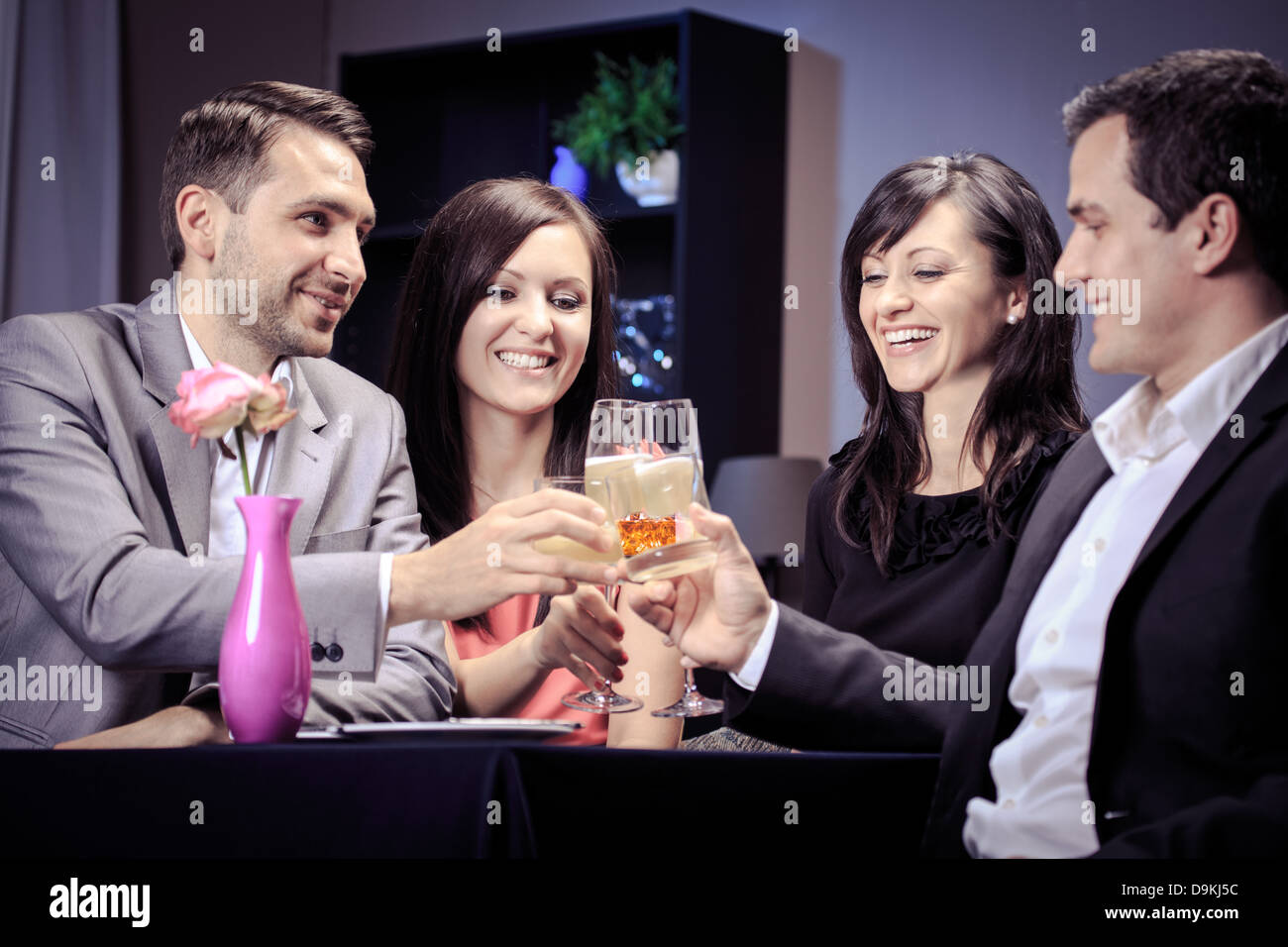 two couples by eating in a restaurant Stock Photo - Alamy