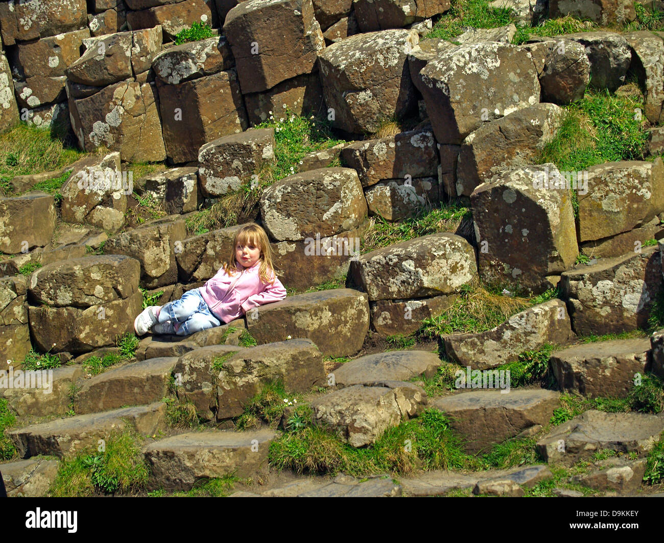 A little Irish lady posing among the hexagonal columns of Giant's ...