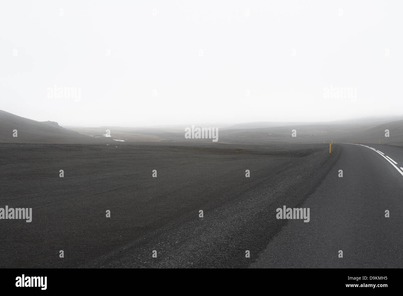 Grey road in empty landscape Stock Photo - Alamy