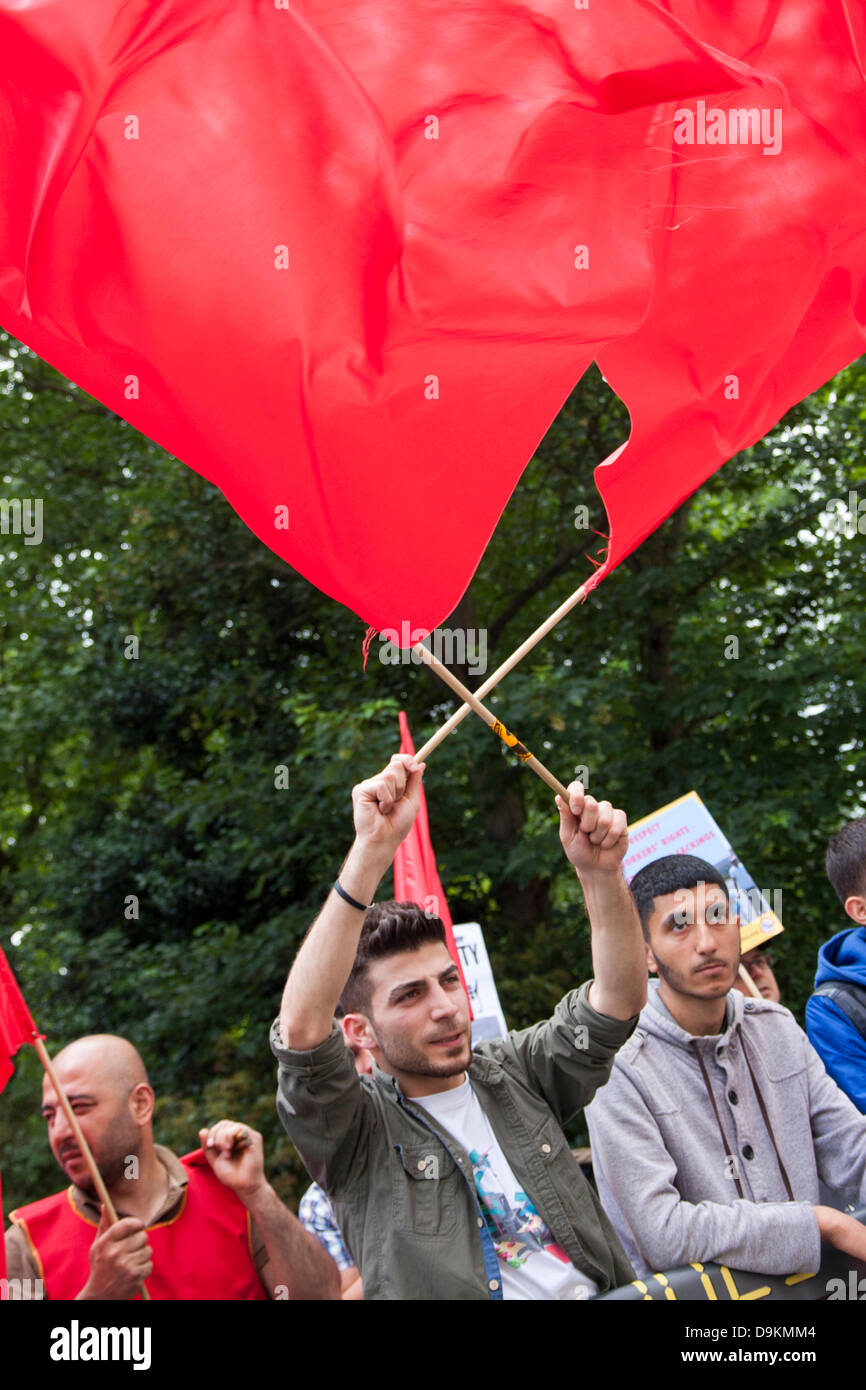 London, UK. 21st June 2013. An activist waves his flags as British ...