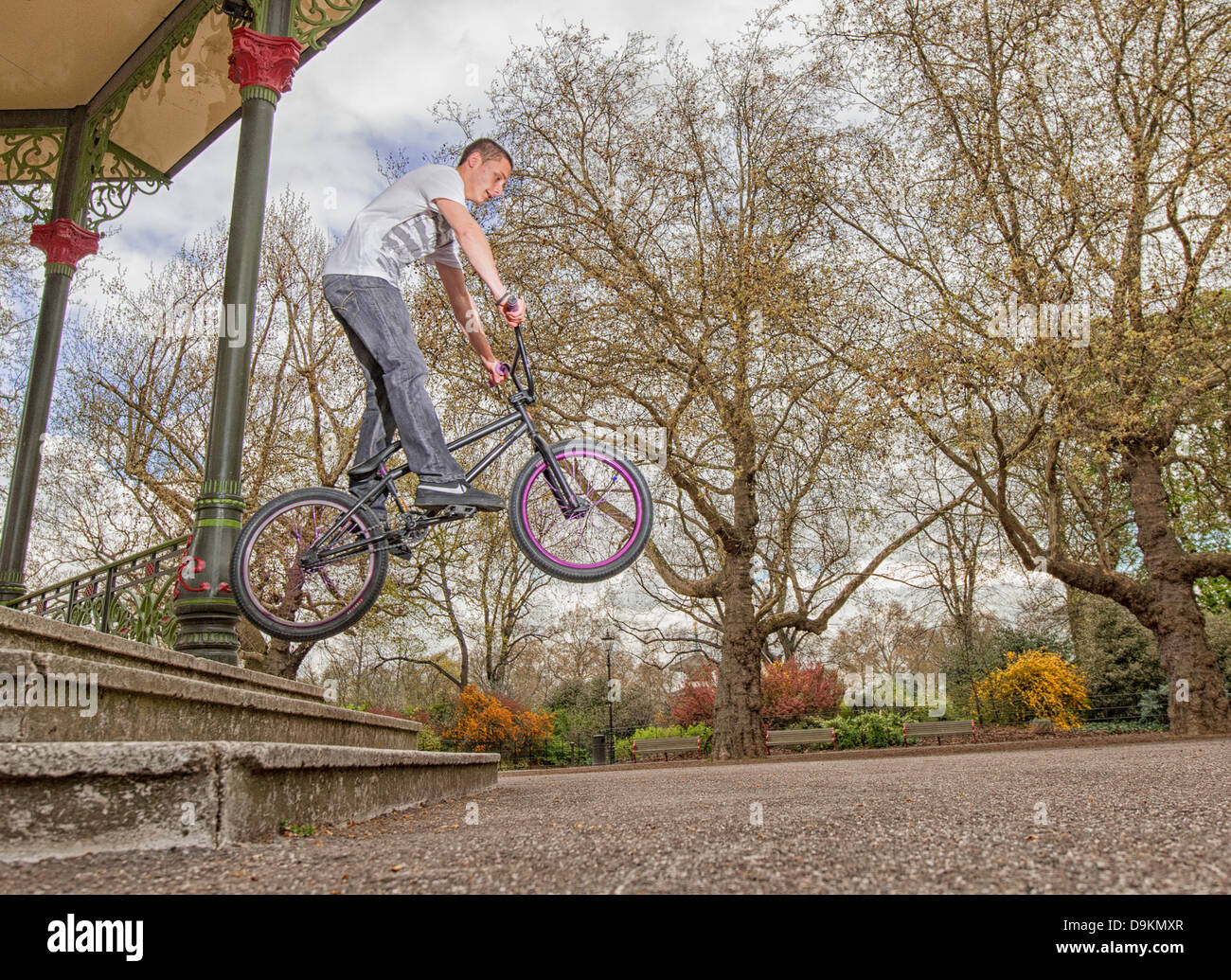 Young boy on bike jumping off steps Stock Photo - Alamy