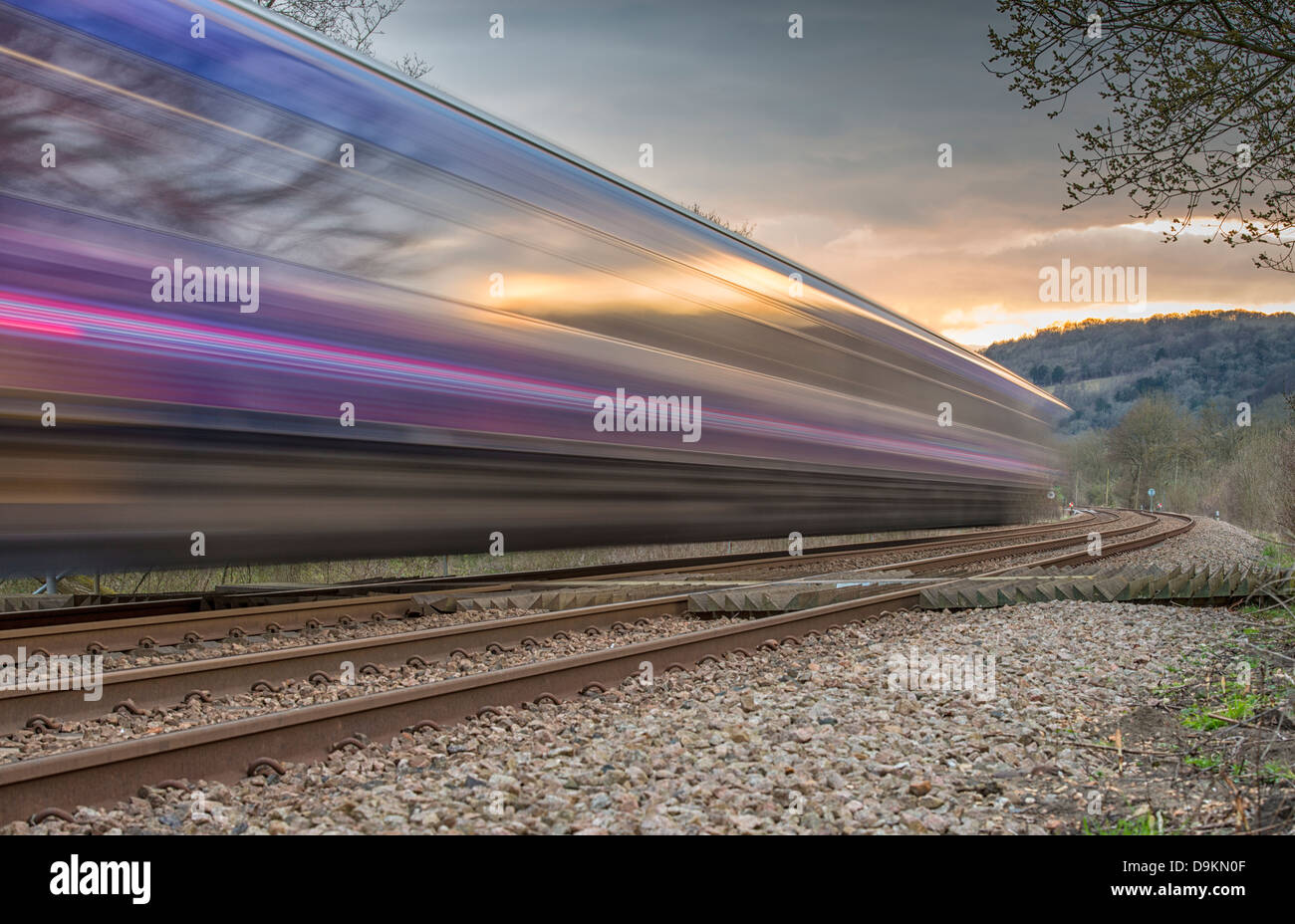 A blurred speeding train in Dorking, Surrey Stock Photo - Alamy