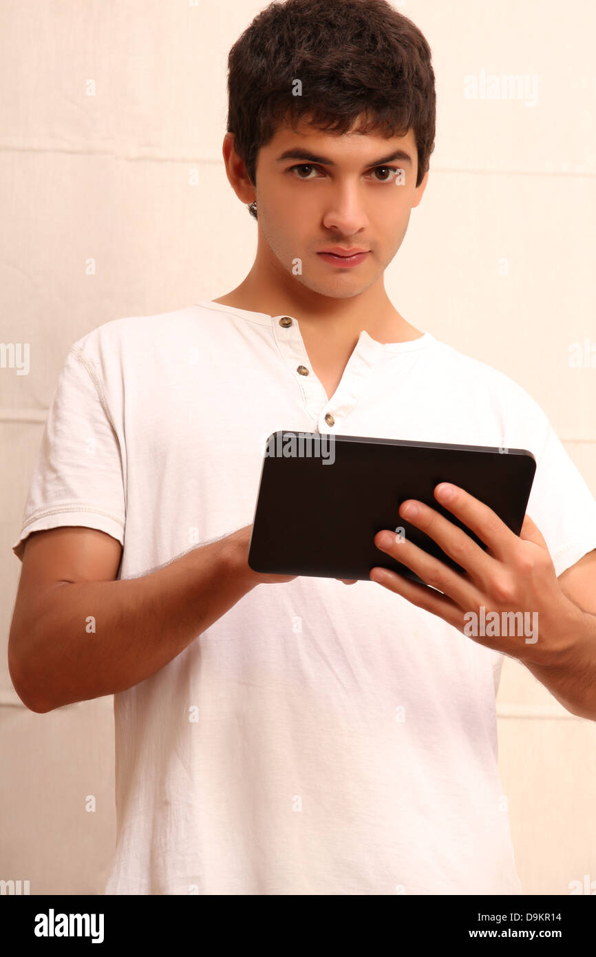 A young, latin man with a Tablet PC, face in focus Stock Photo - Alamy