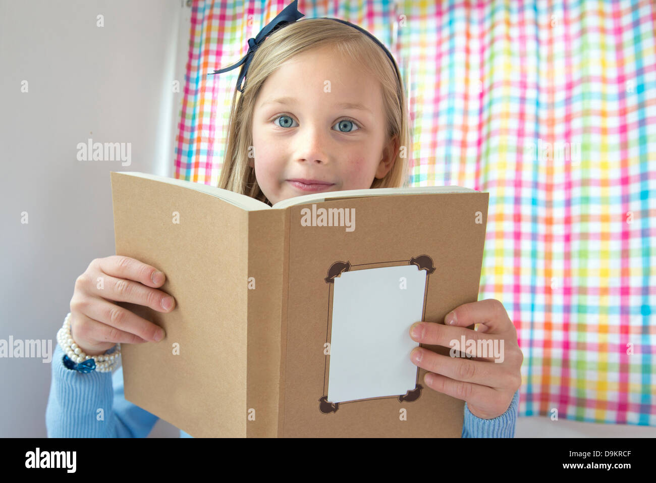 Portrait of young girl reading book Stock Photo - Alamy