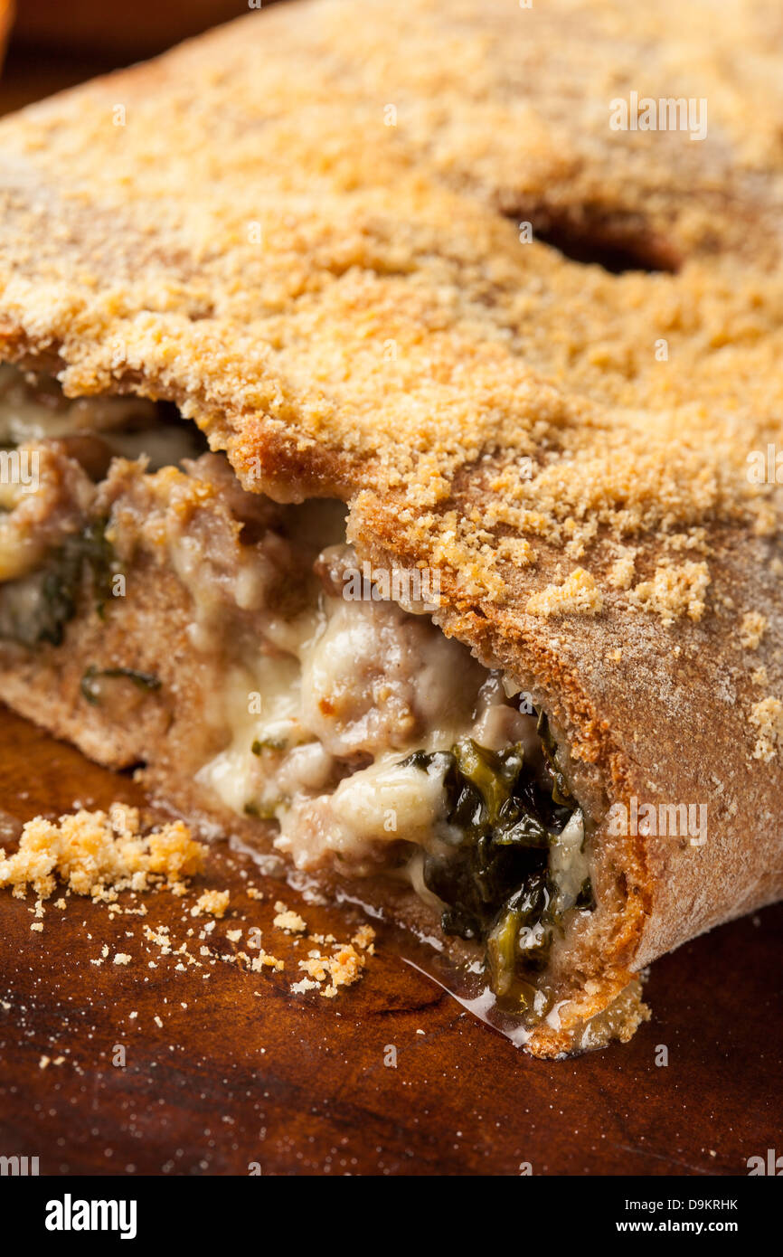 Fresh Homemade Italian Calzone with sausage and spinach Stock Photo - Alamy