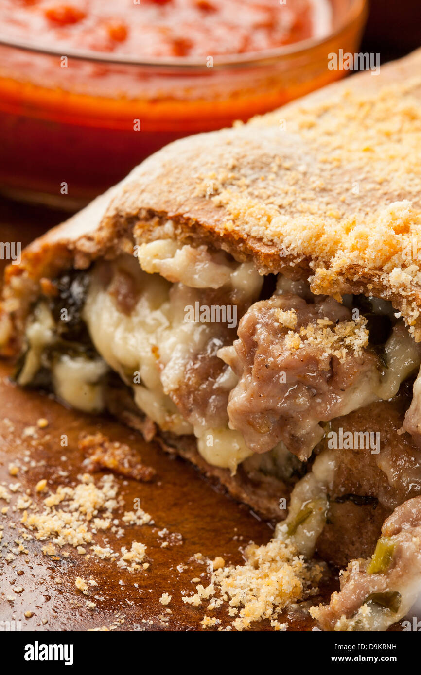Fresh Homemade Italian Calzone with sausage and spinach Stock Photo - Alamy