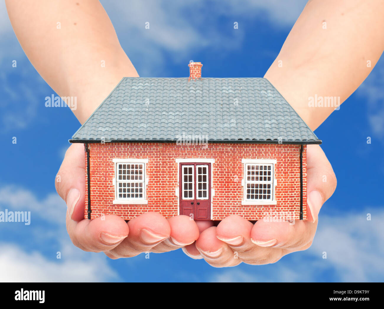 Small house in hands Stock Photo - Alamy
