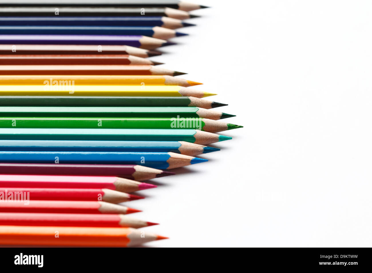 A Colored Pencils arranged horizontally in a line Stock Photo - Alamy