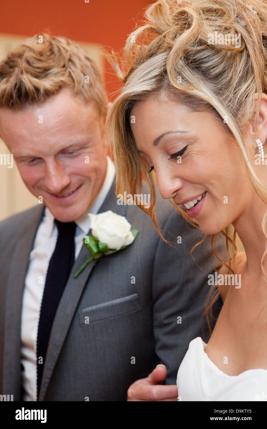 Bride and groom smiling at wedding ceremony Stock Photo - Alamy
