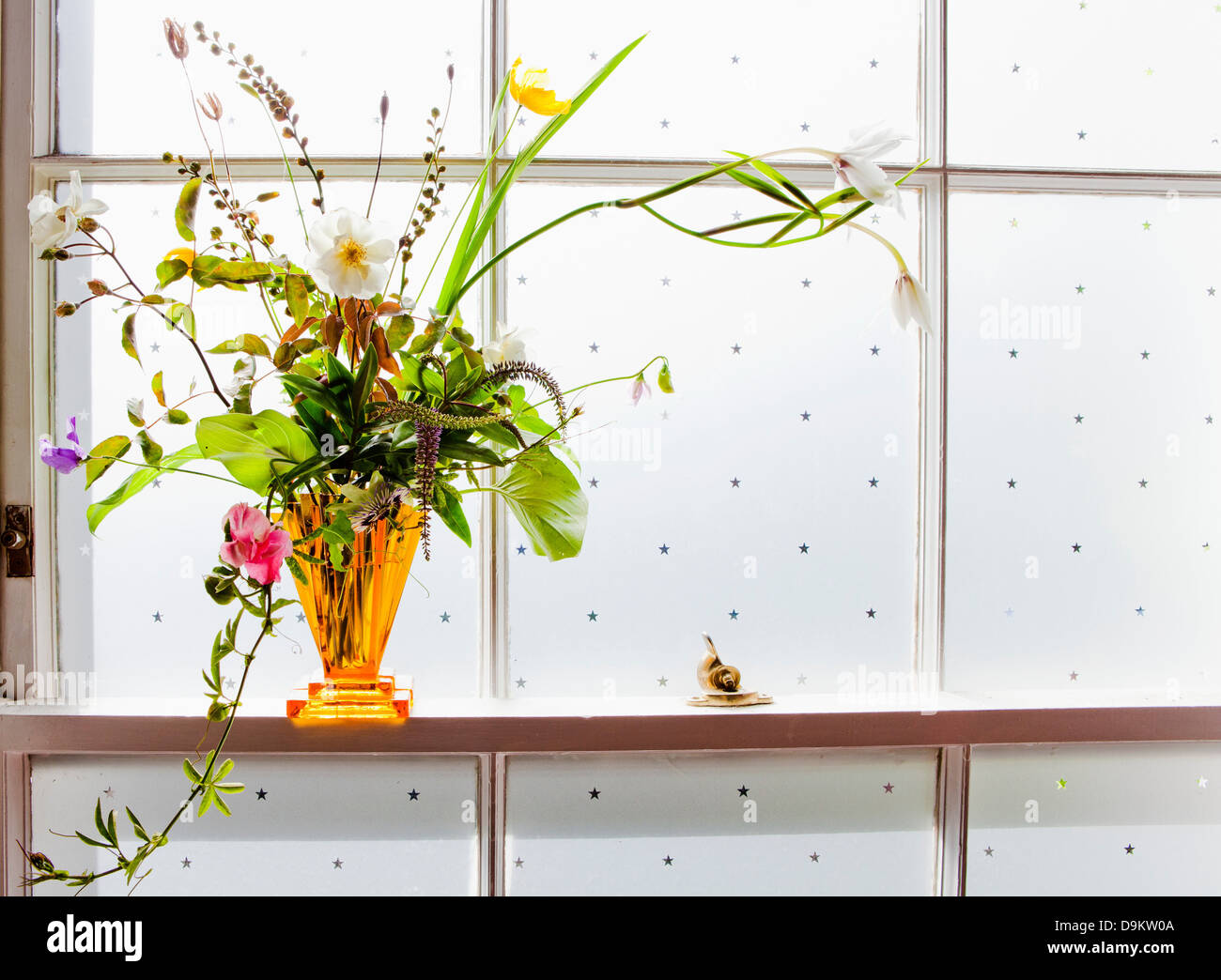 Flower arrangement in vase by window Stock Photo - Alamy