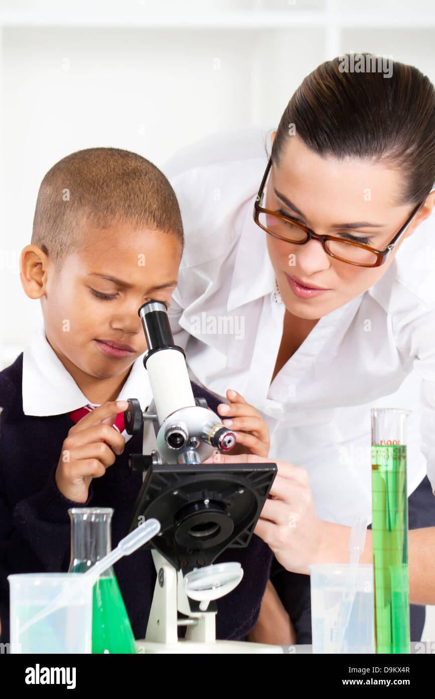 beautiful young teacher helping school boy in science class Stock Photo ...