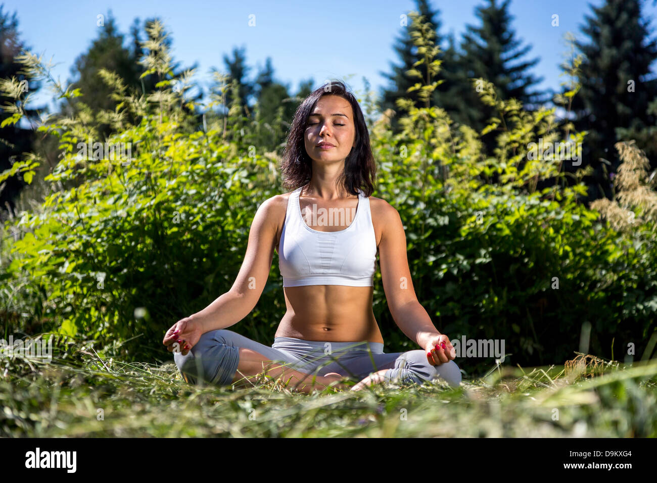 girl doing yoga outdoor with closed eyes, ladscape Stock Photo - Alamy