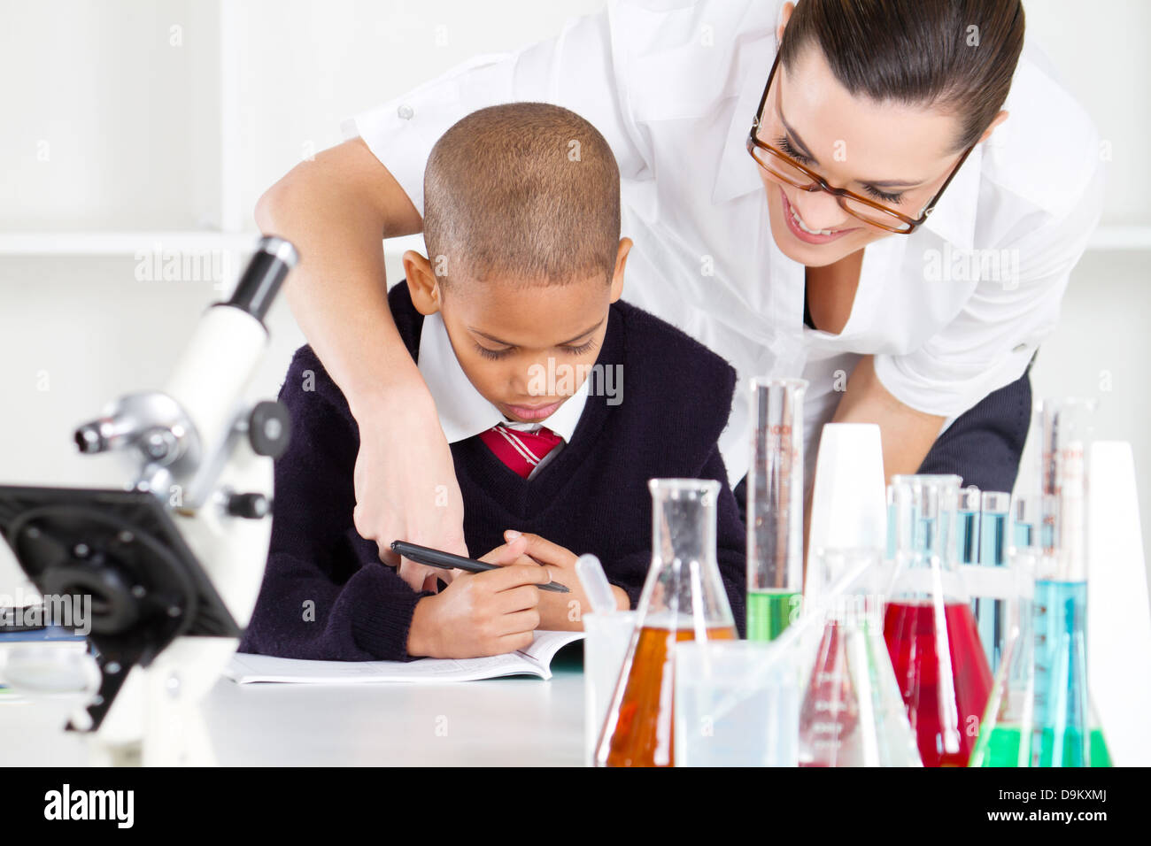 elementary science teacher and student in lab Stock Photo - Alamy
