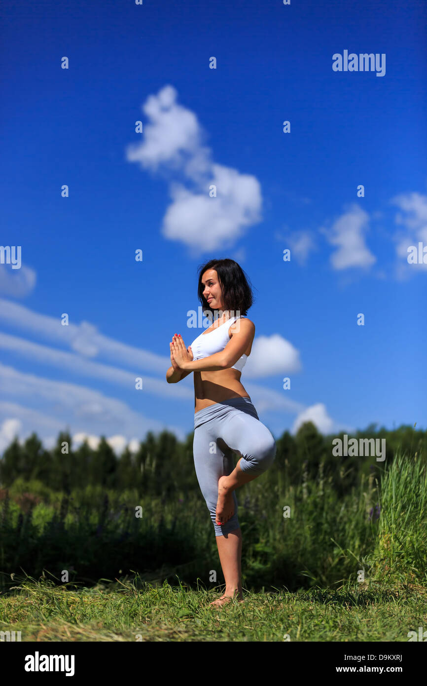 girl doing yoga outdoor with open eyes, vertical Stock Photo - Alamy