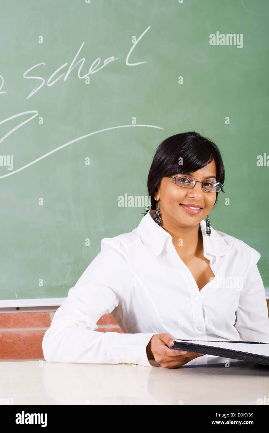 young school teacher sitting in class Stock Photo - Alamy