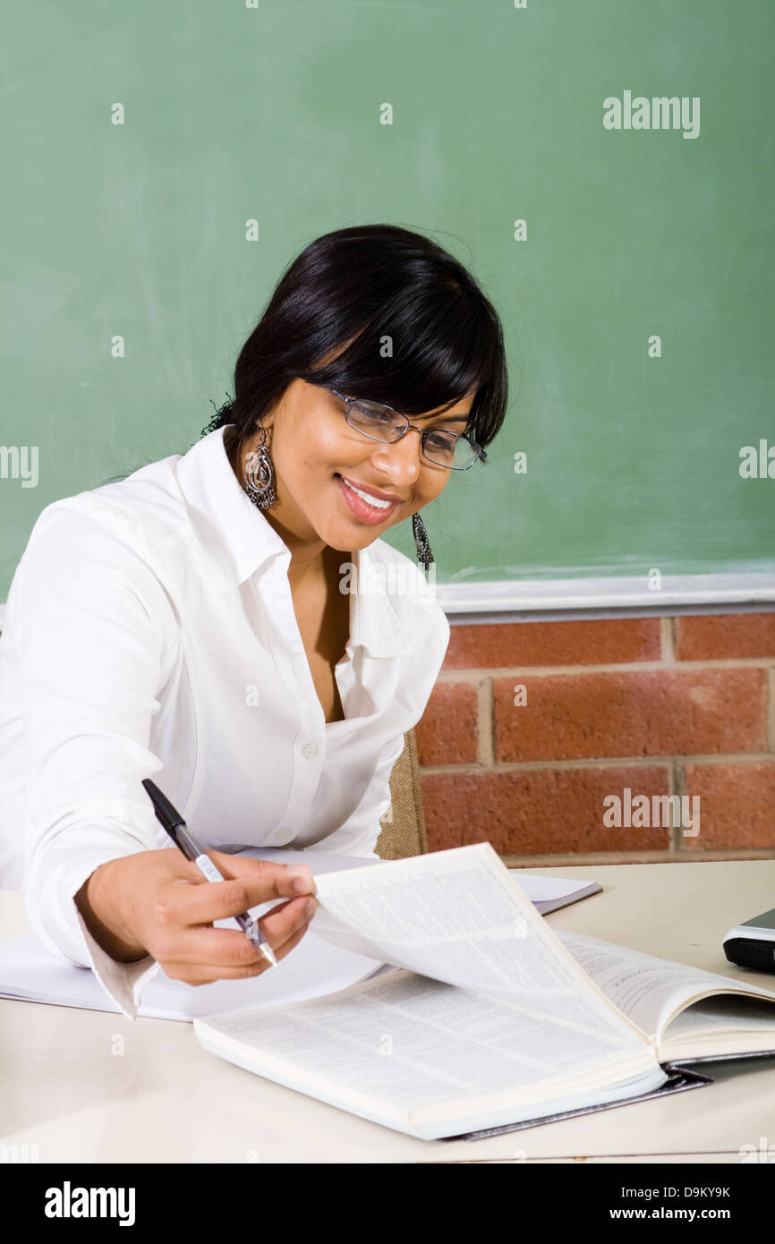 young pretty school teacher working in classroom Stock Photo - Alamy