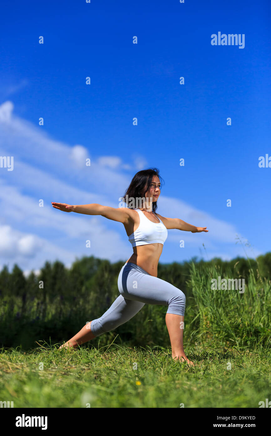 girl doing yoga outdoor with open eyes, vertical Stock Photo - Alamy