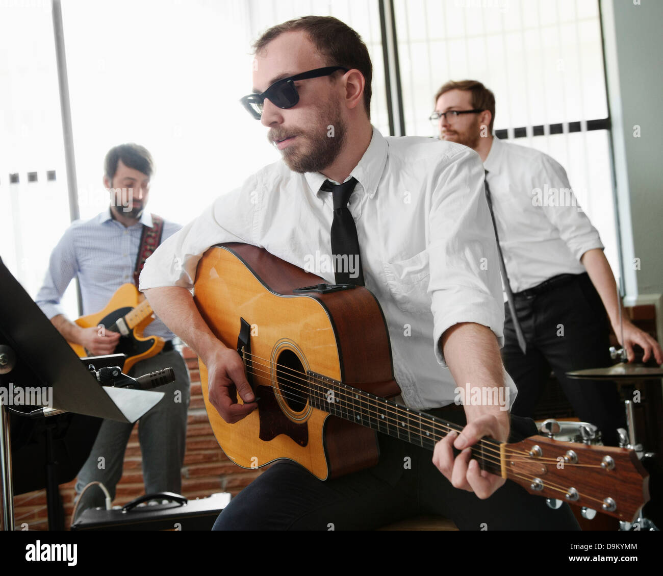 Young man playing guitar in rehearsal room Stock Photo - Alamy