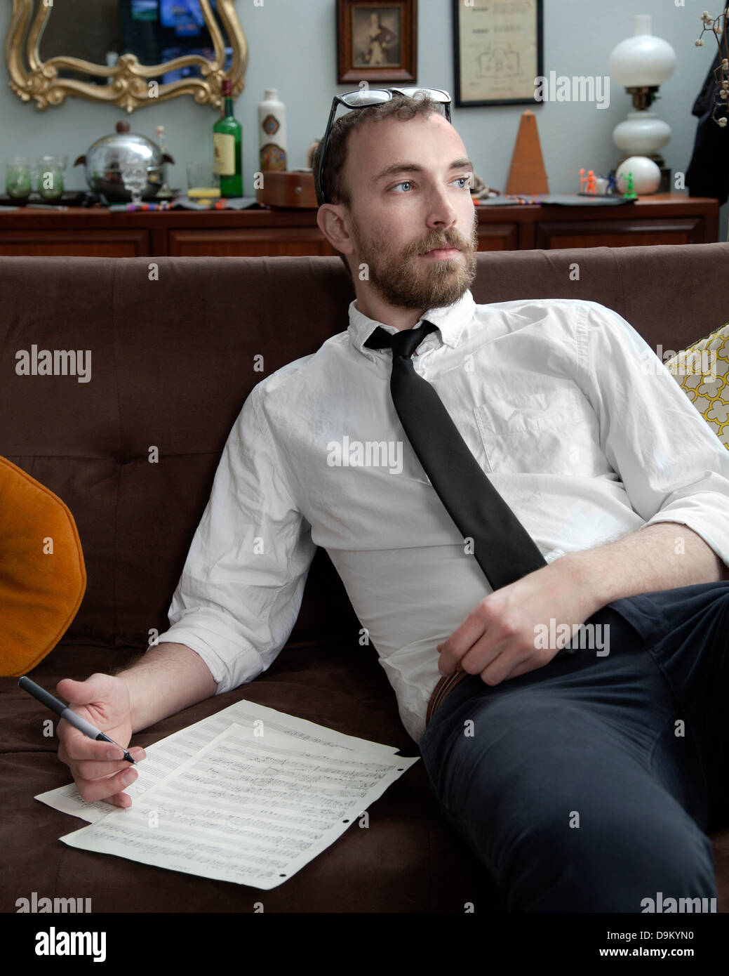 Young Man Writing Sheet Music And Looking Away Stock Photo Alamy young-man-writing-sheet-music-and-looking-away-stock-photo-alamy