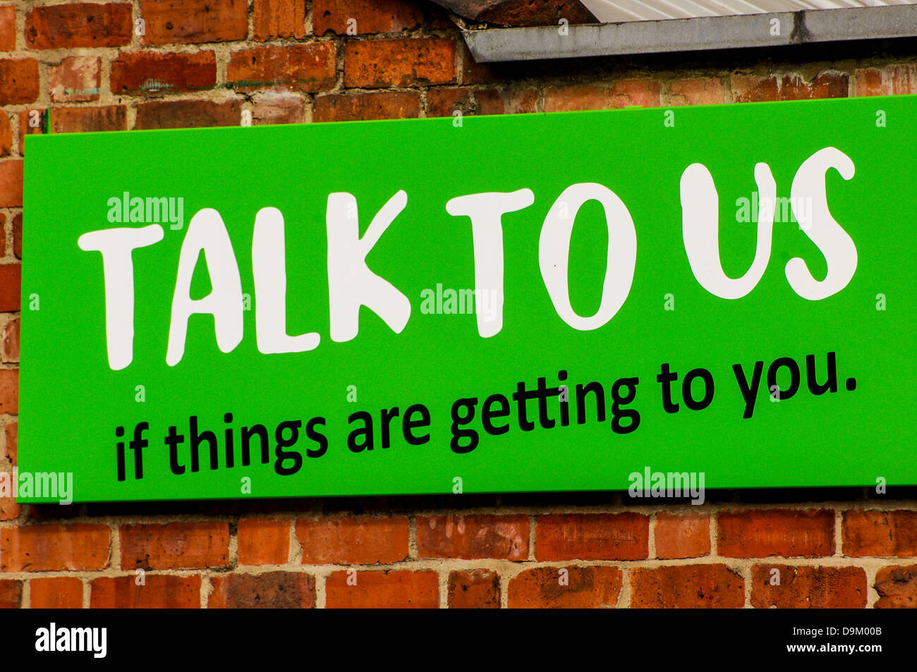 Talk to us sign on a Samaritans building Stock Photo - Alamy