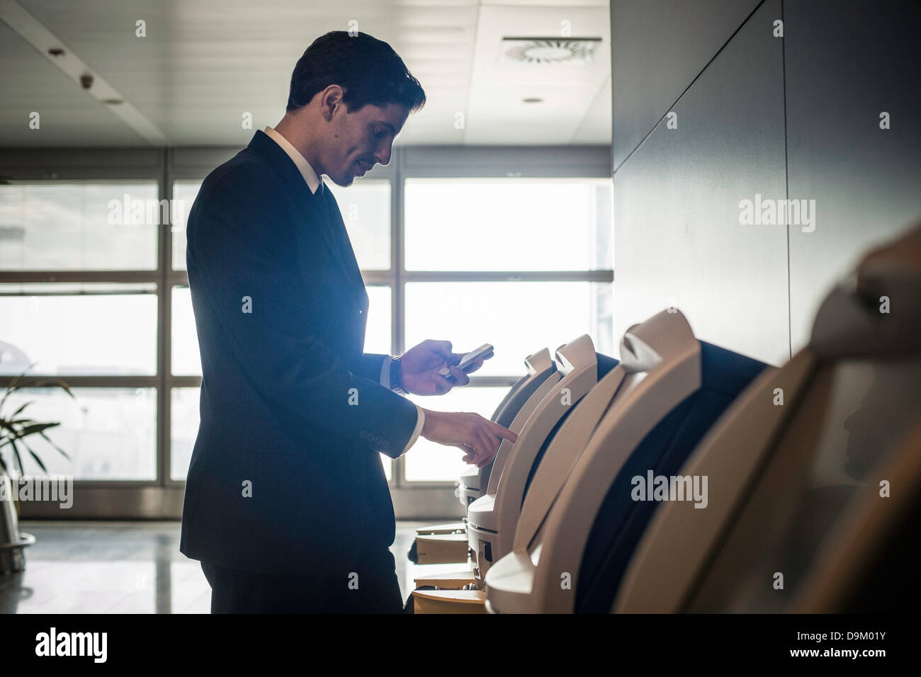 Businessman at airport check in area Stock Photo - Alamy