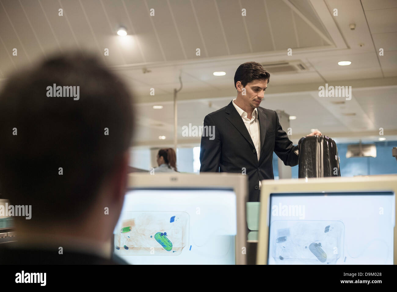 Security guard checking luggage on monitor in airport Stock Photo - Alamy