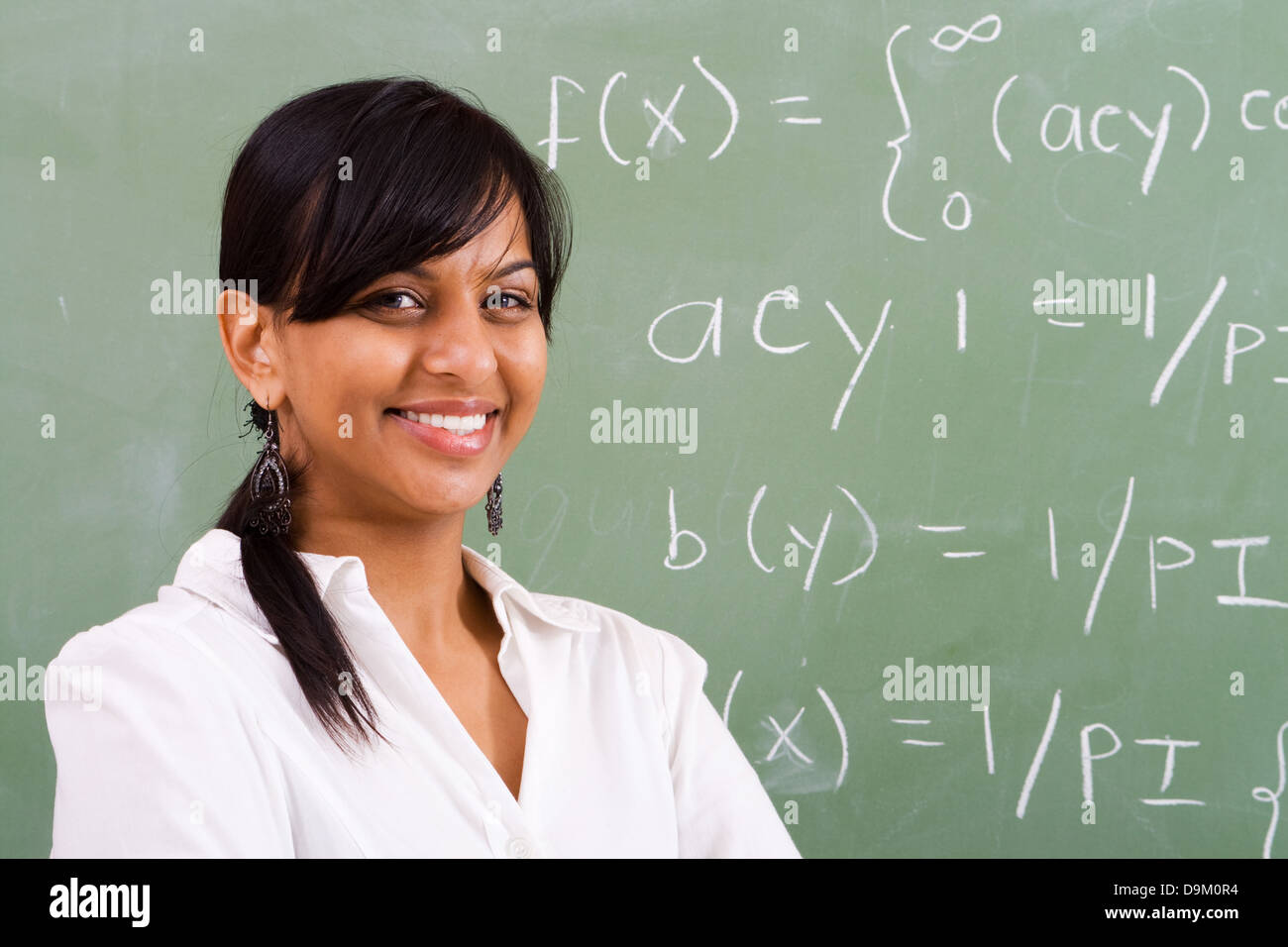 young female math teacher in front of chalkboard Stock Photo - Alamy