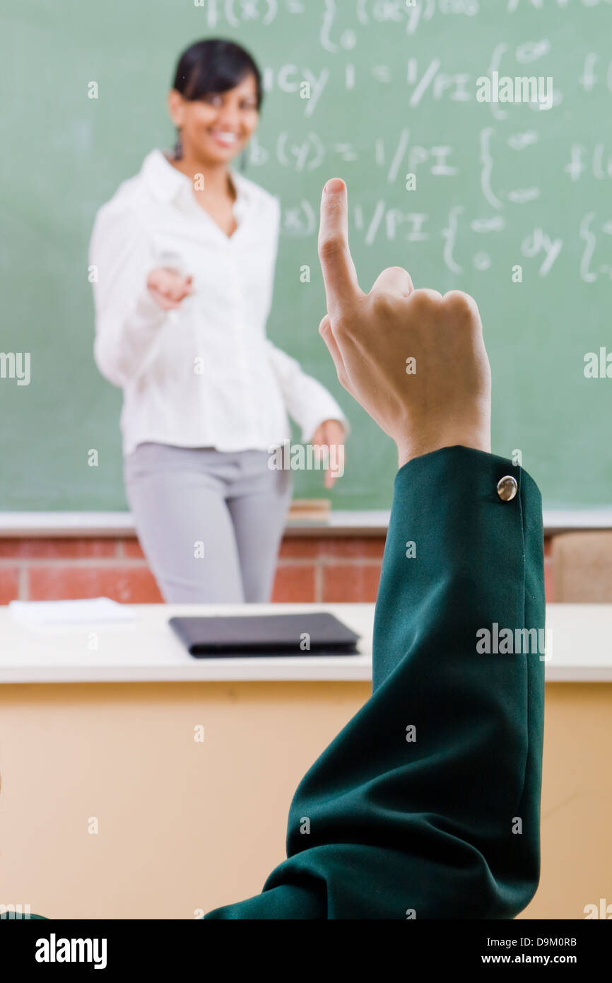 student hand up in classroom to answer teacher's question Stock Photo ...