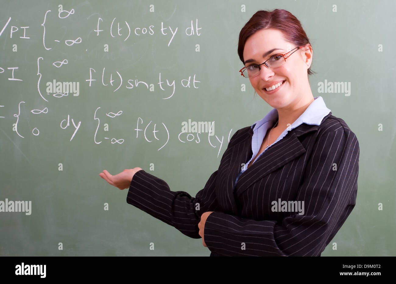 attractive young female teacher in front of blackboard Stock Photo - Alamy