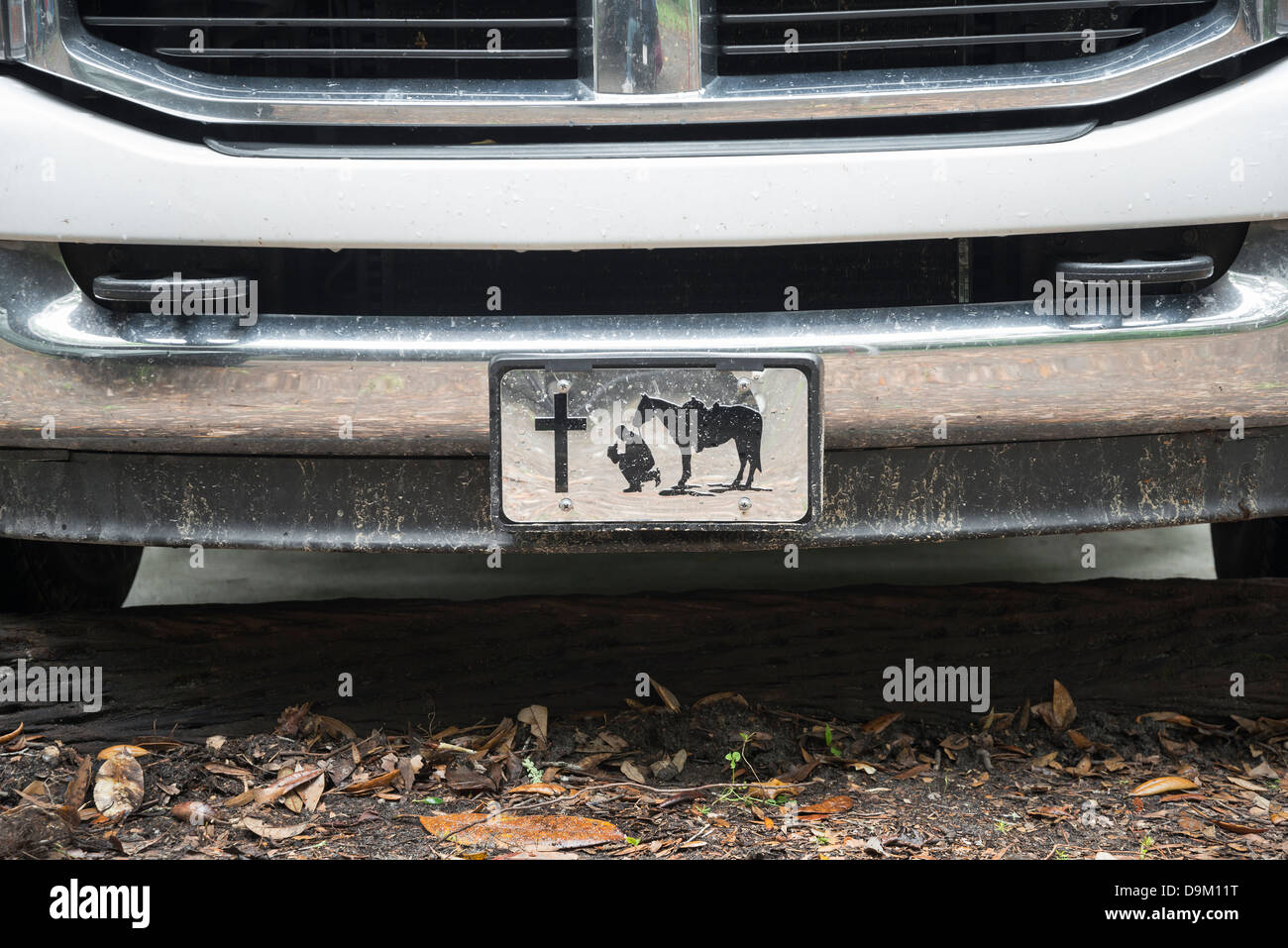 Christian license plate depicting cowboy kneeling at Cross Stock Photo ...