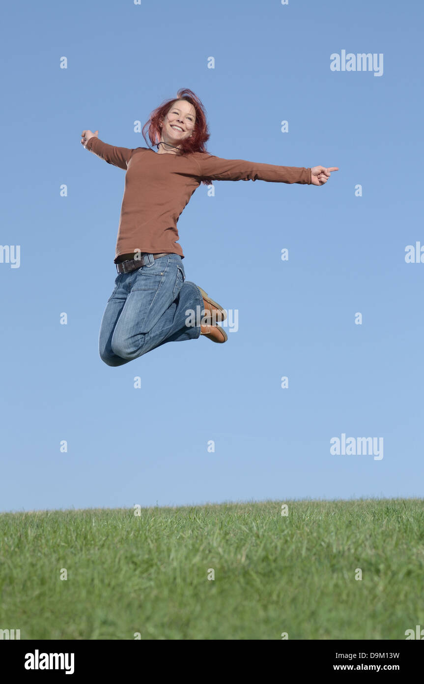 Active woman making free jump outdoors recreation Stock Photo - Alamy