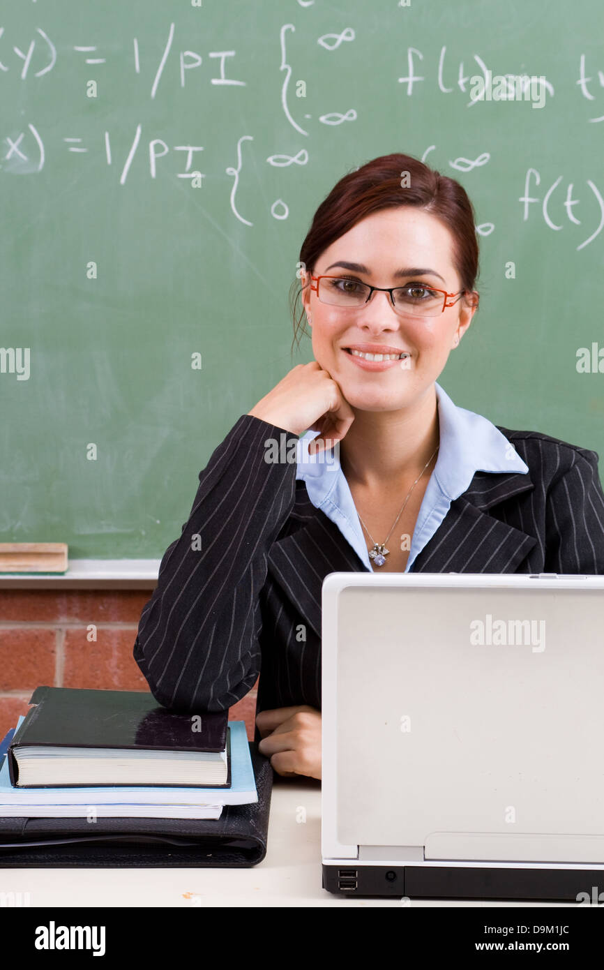 happy attractive female teacher sitting in front of blackboard Stock ...