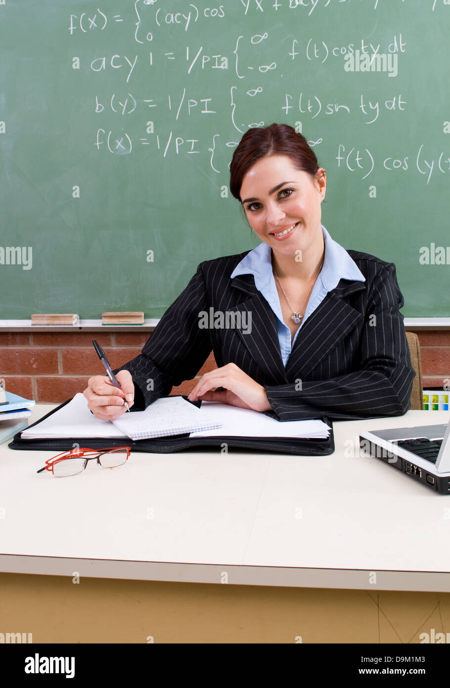female school teacher working in classroom Stock Photo - Alamy
