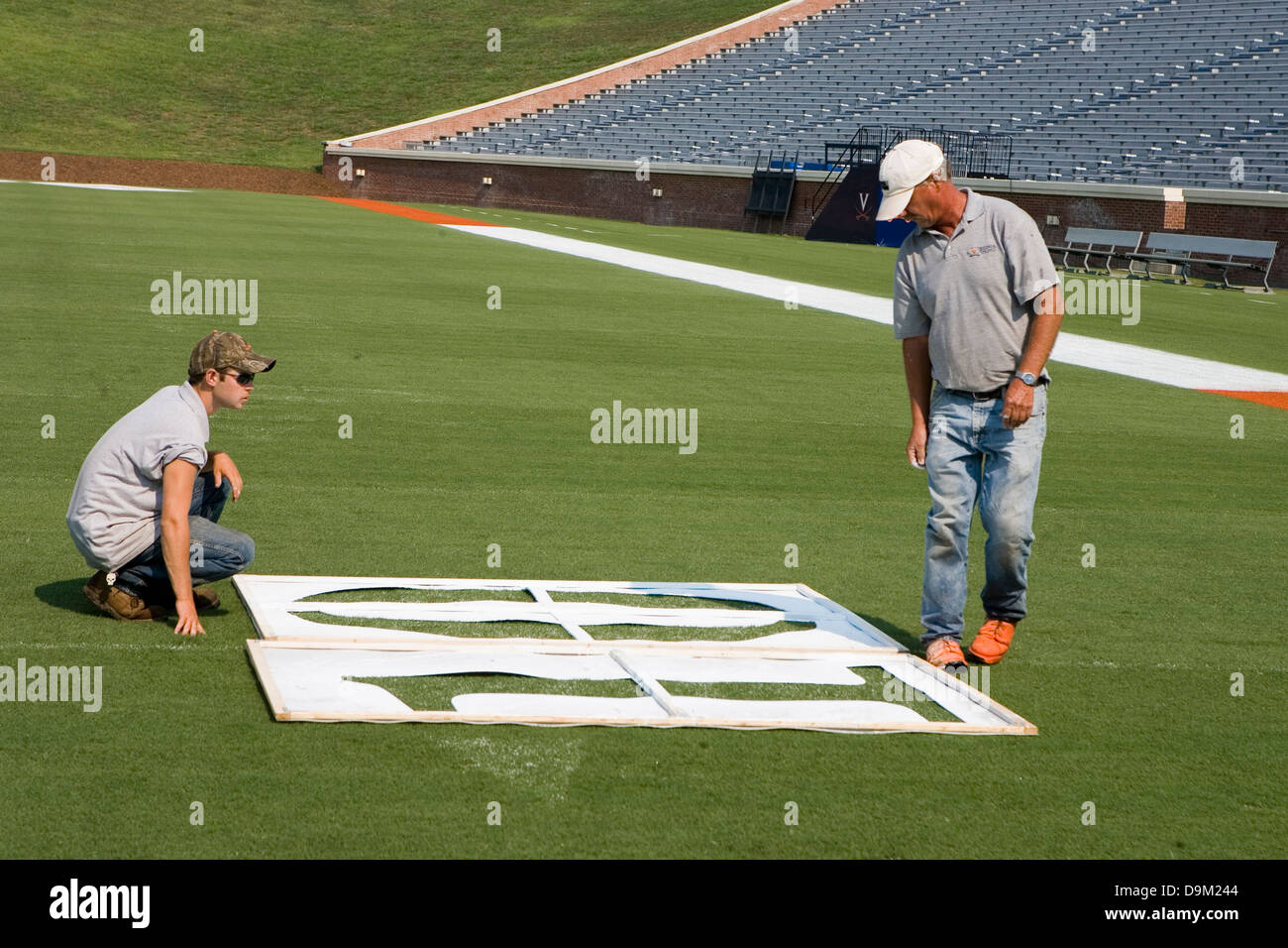 The University of Virginia Sports Field Management staff paints the ...