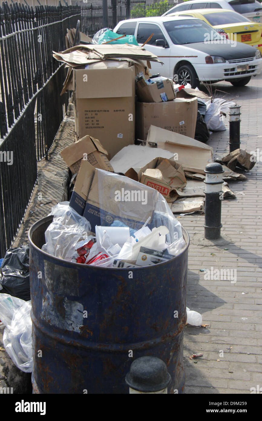 Trash piled up in a large bin and in a street, without sorting, in the ...