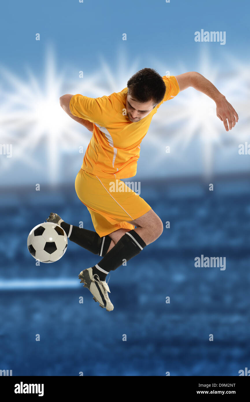 Soccer player performing back kick in stadium at dusk Stock Photo - Alamy