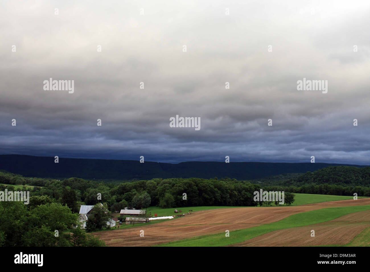 storm clouds over rural farm house and fields in Beech Creek, Clinton ...
