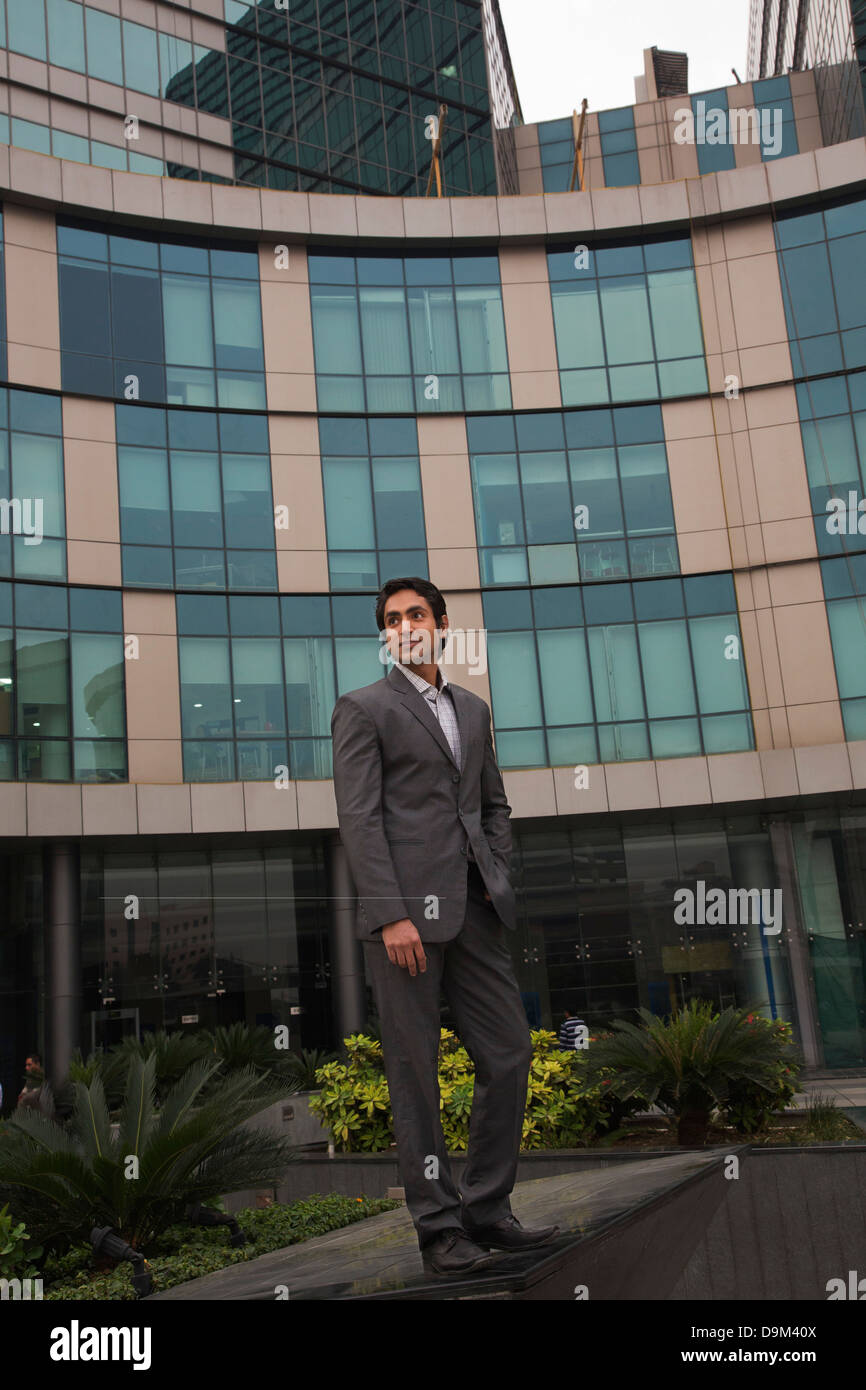 Businessman standing outside an office building Stock Photo - Alamy