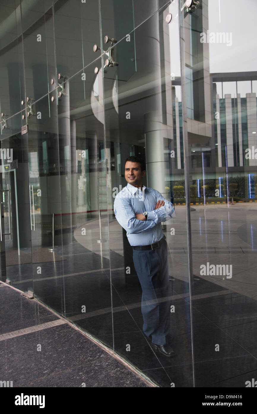 Indian business man standing against wall hi-res stock photography and ...