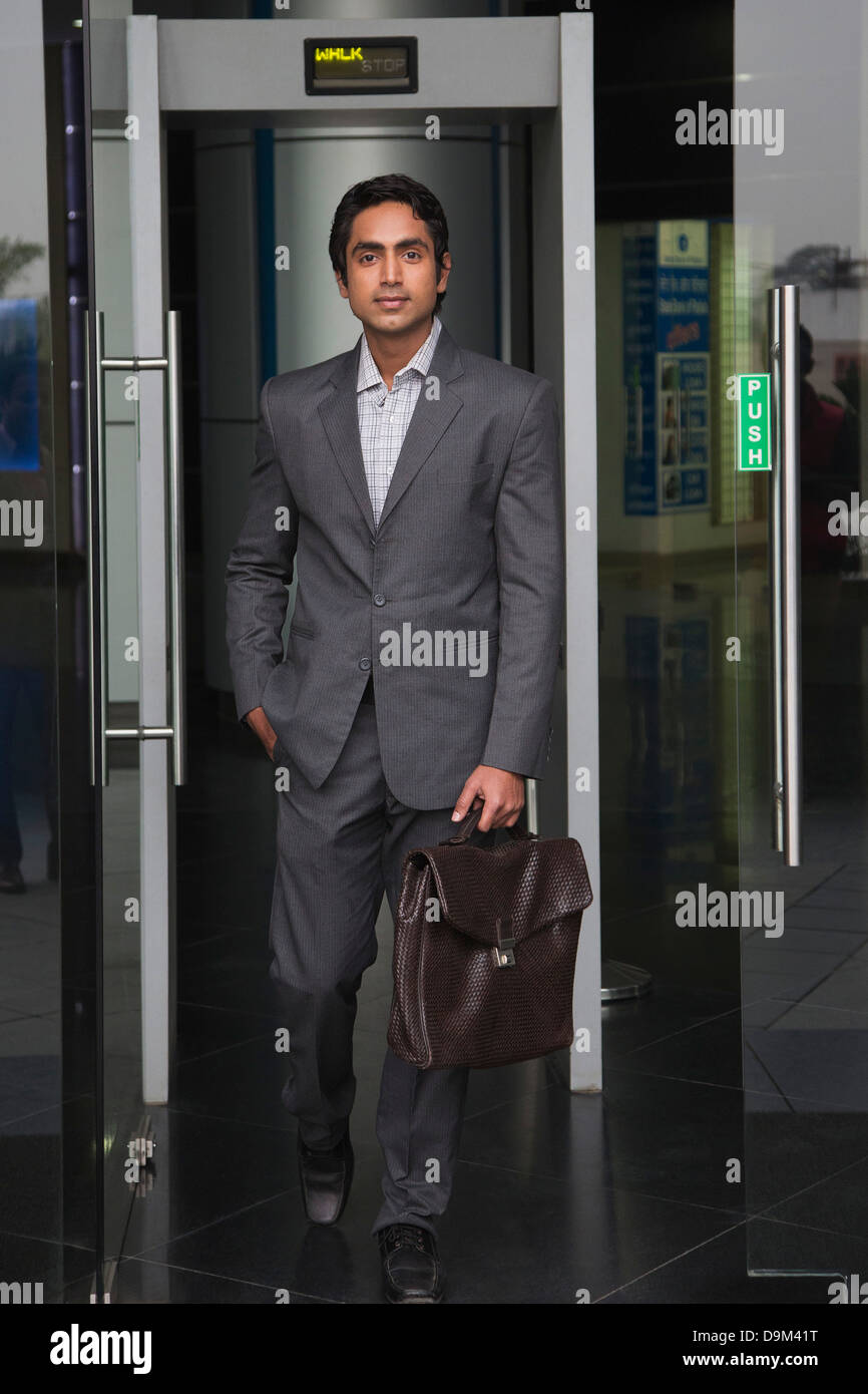 Businessman crossing security check system in an office Stock Photo - Alamy