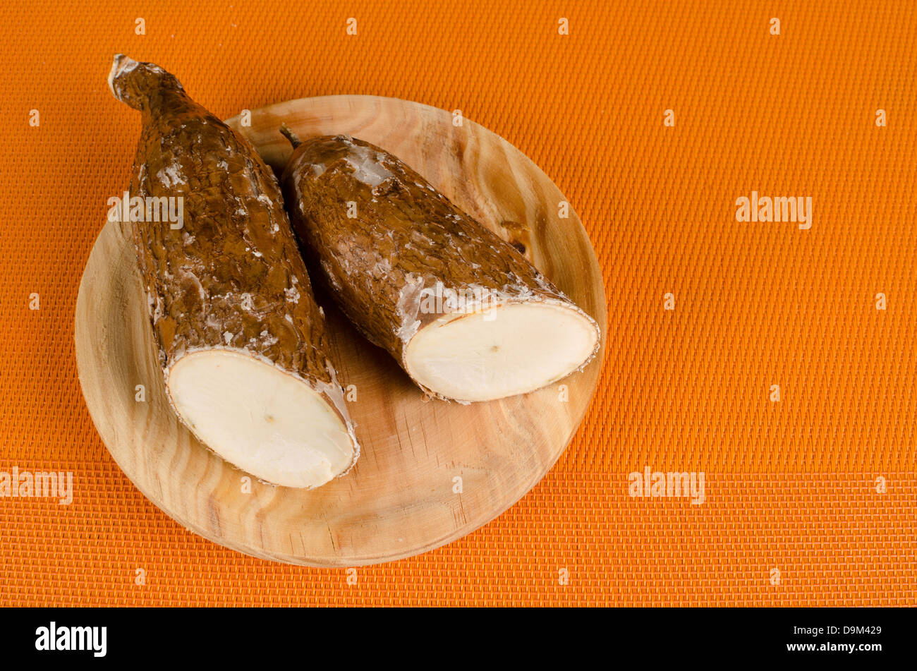 Cassava root cut in two displaying its white interior Stock Photo - Alamy