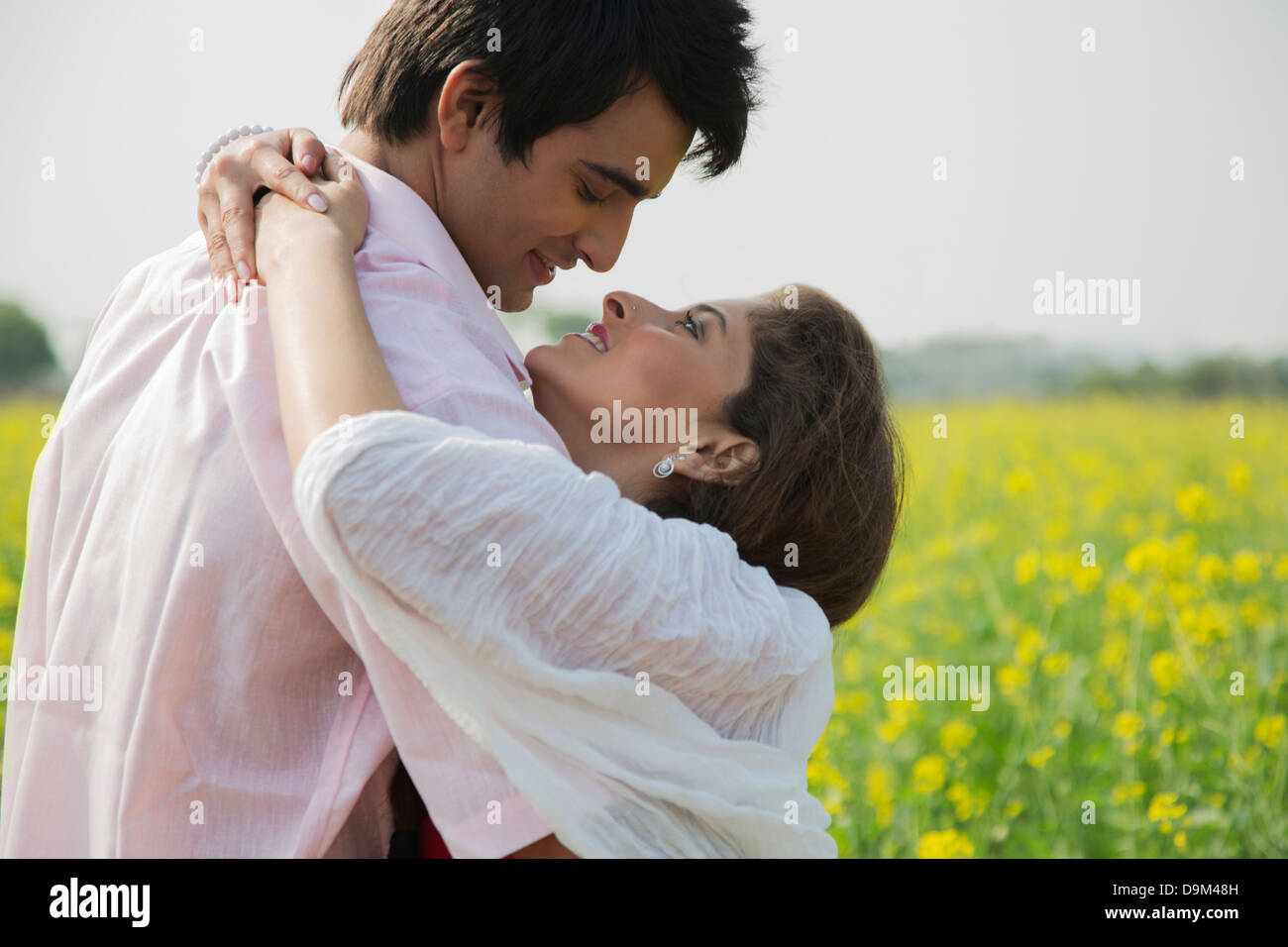 Couple embracing each other and smiling Stock Photo - Alamy