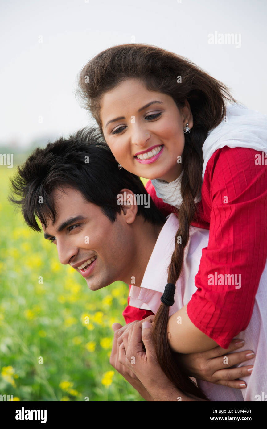 Woman riding on mans shoulders hi-res stock photography and images - Alamy