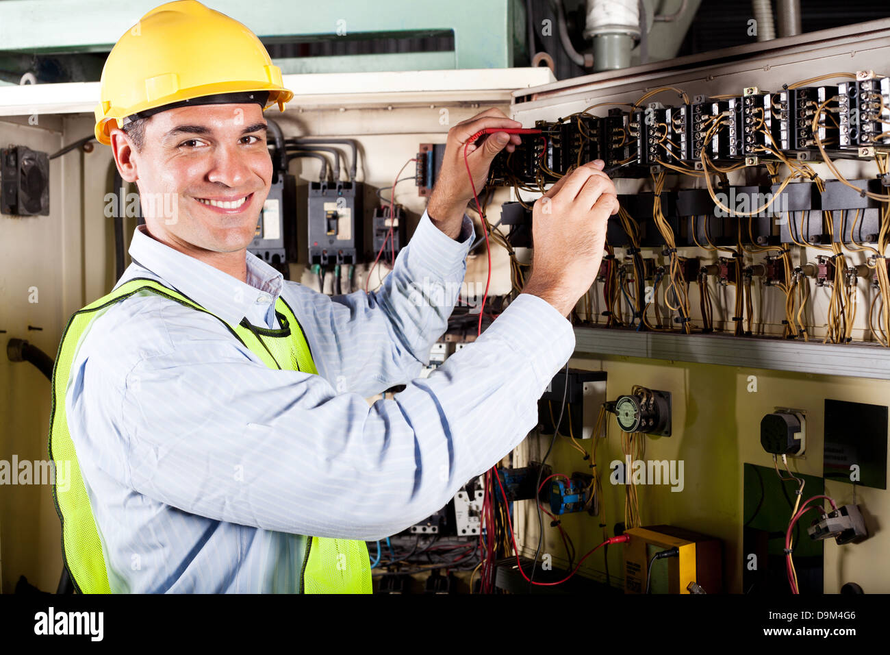 happy male electrician working on industrial machine Stock Photo - Alamy