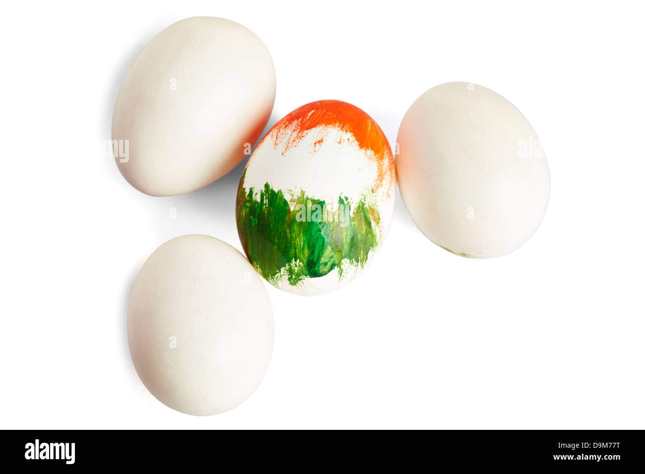 Tri coloured egg surrounded with white eggs Stock Photo - Alamy