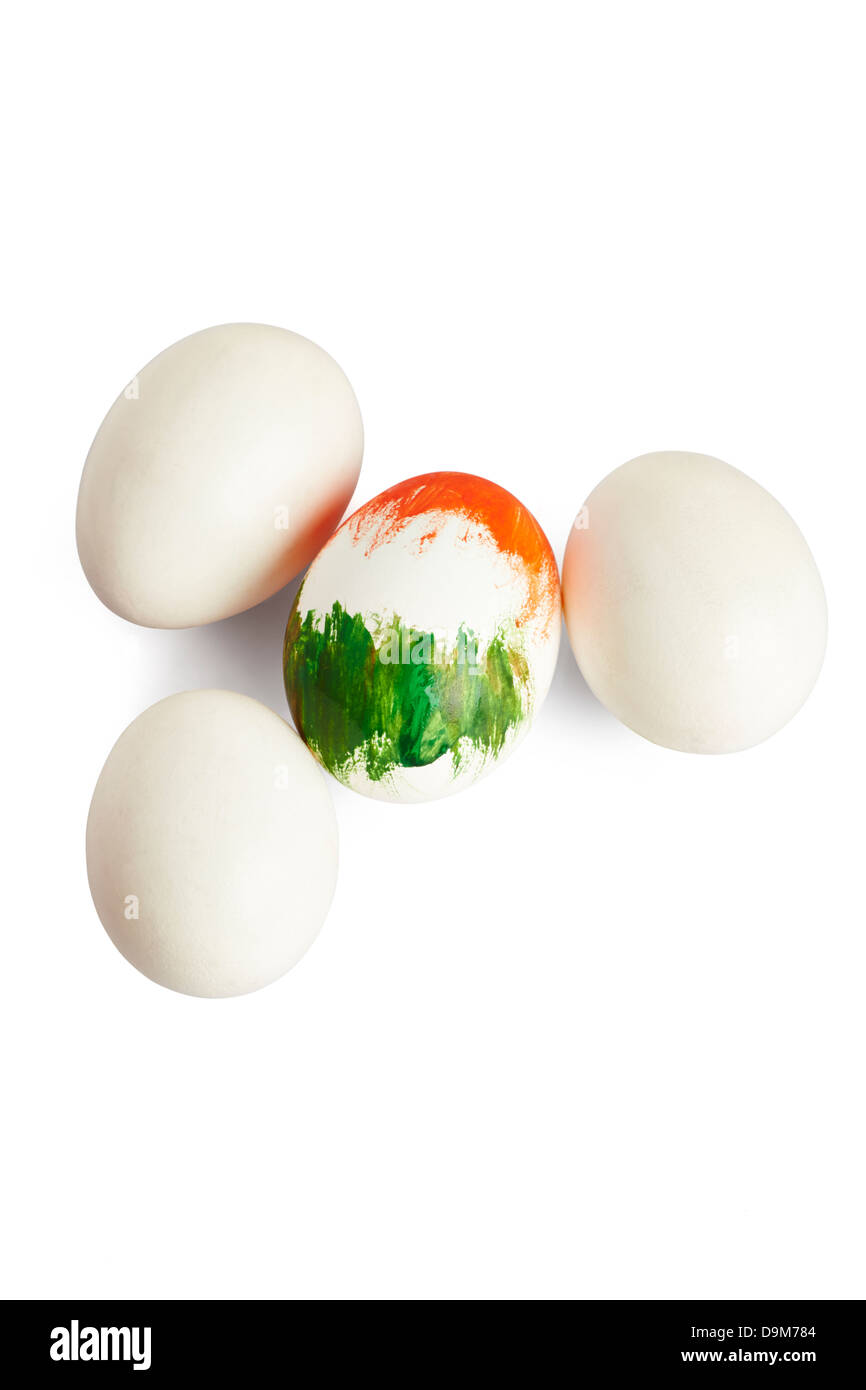 Tri coloured egg surrounded with white eggs Stock Photo - Alamy
