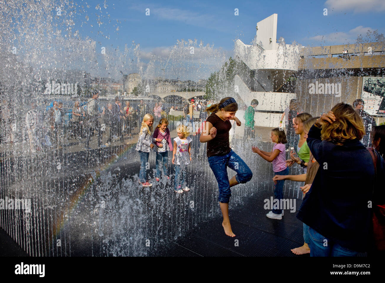 Children and adults playing in the water fountains on the southbank at ...