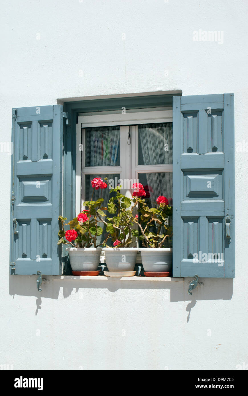 Traditional Greek window with flowers on Mykonos island, Greece Stock ...