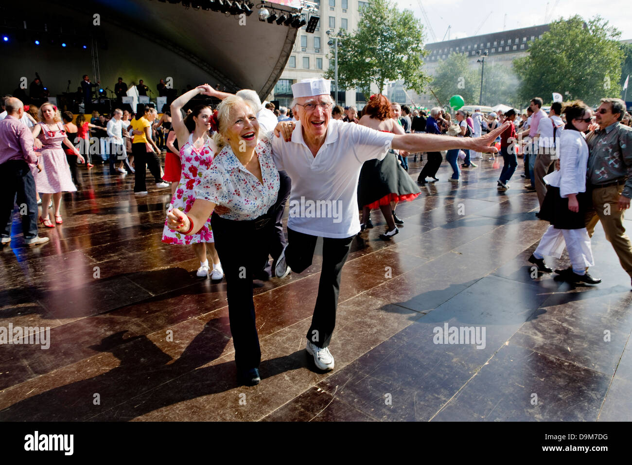 Swing and jive dancers on the glittering outdoor ballroom in the ...