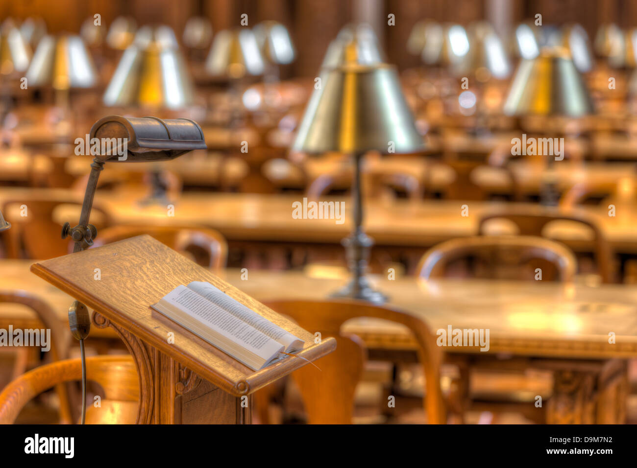 A book rests on a reading stand in front of reading tables in the Rose ...